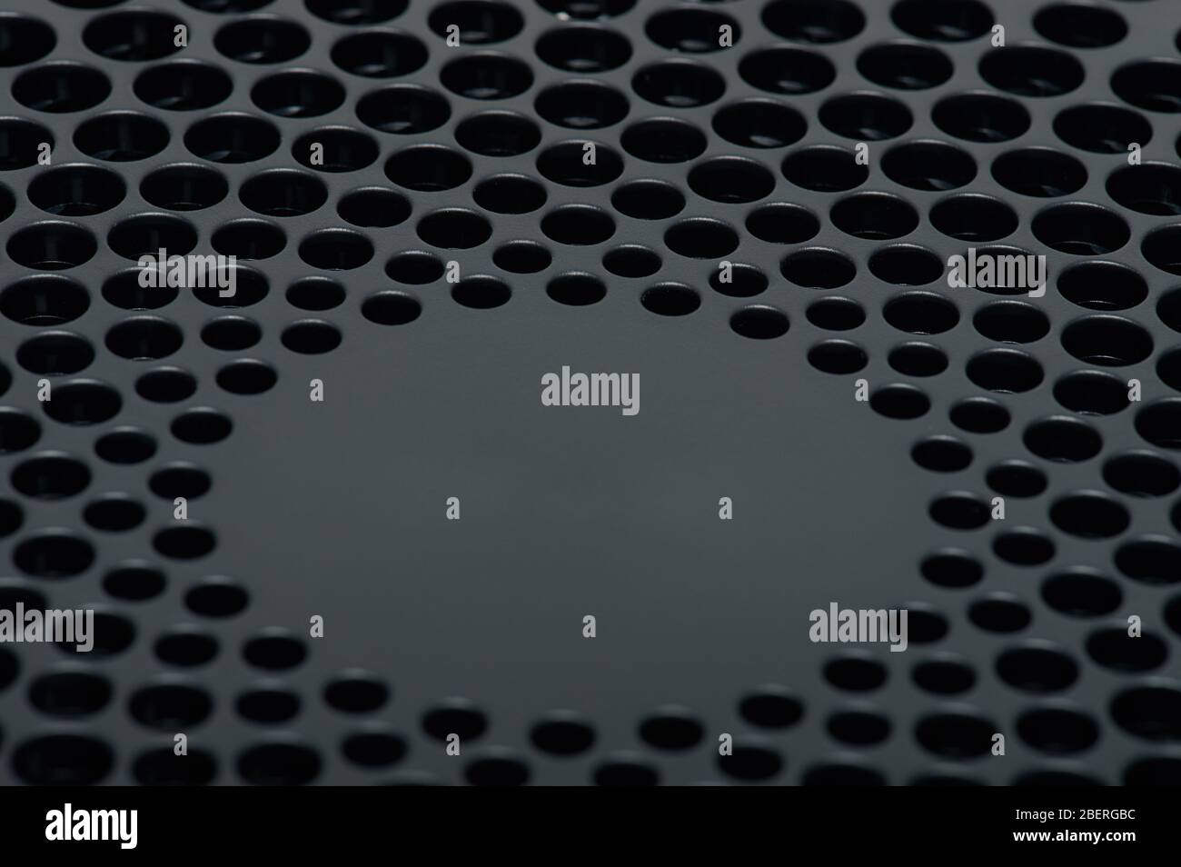 Pattern of vent holes in black plastic surface clsoe up view Stock ...