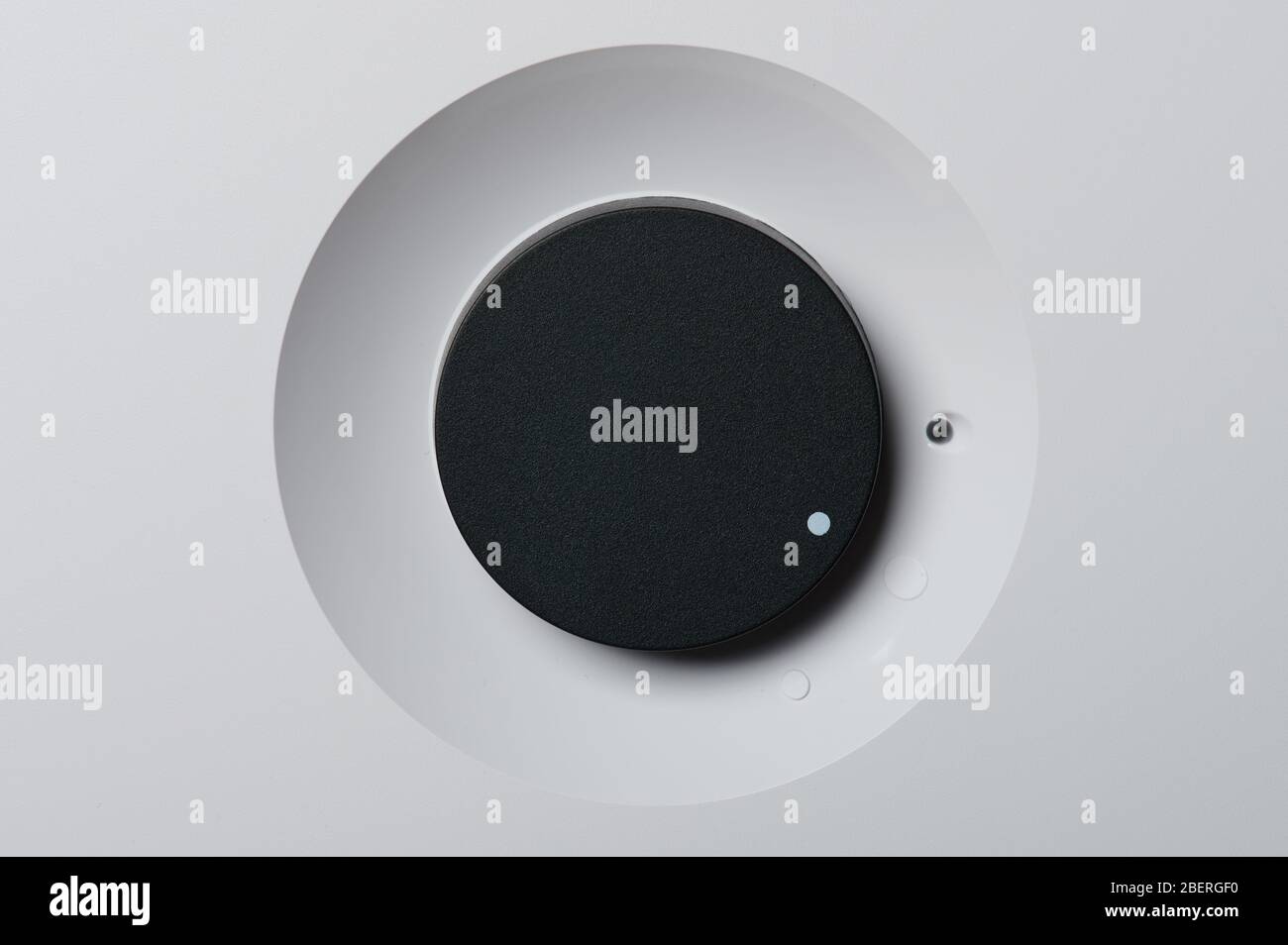 Black round knob button on white plastic texture background Stock Photo ...