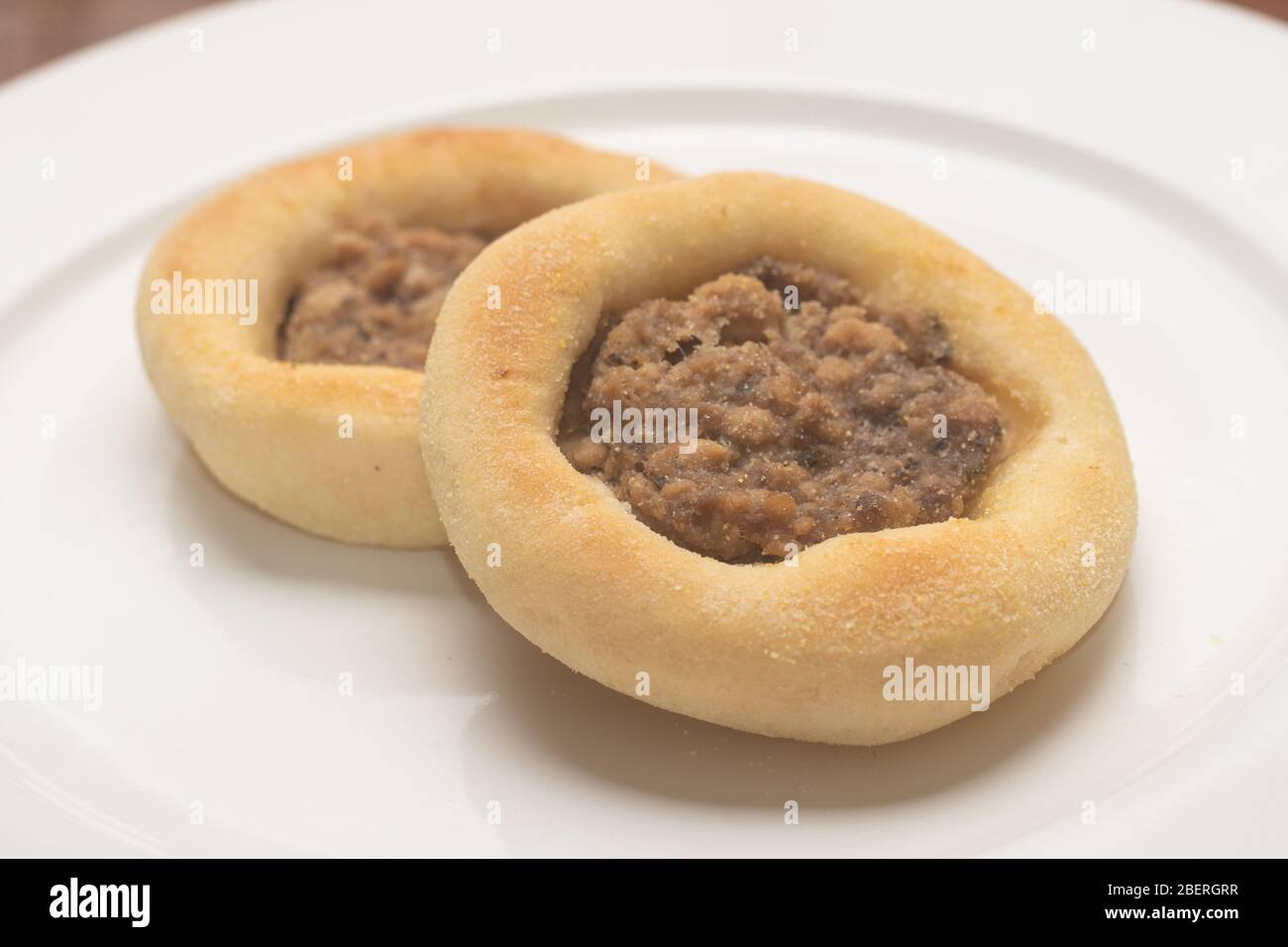 Arabic Meat sfiha over a wooden table. Esfiha or Esfirra. Manakish ...