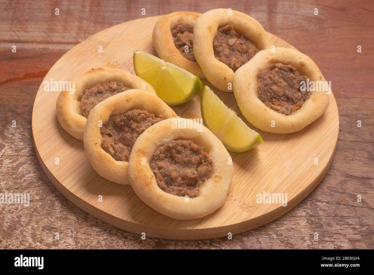 Arabic Meat sfiha over a wooden table. Esfiha or Esfirra. Manakish ...