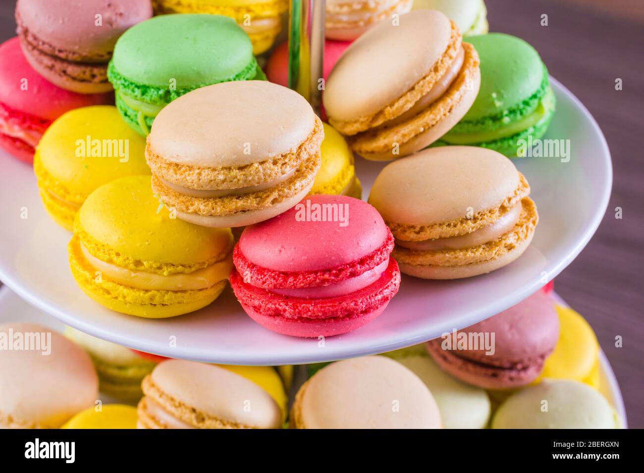 Traditional French Macaroons in various colors on the plate Stock Photo ...