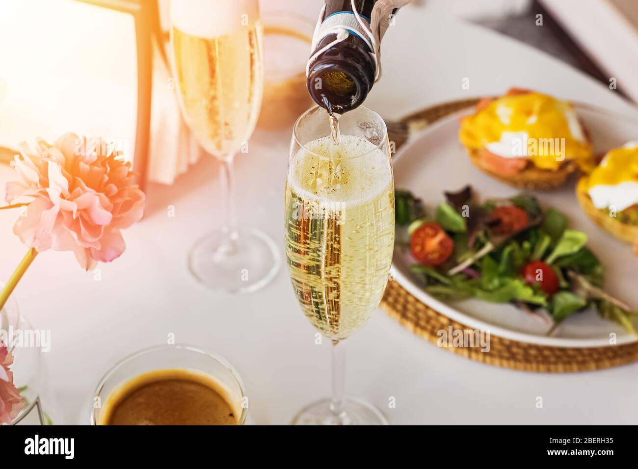 Pouring prosecco sparkling wine in a glass on sunday brunch Stock Photo ...