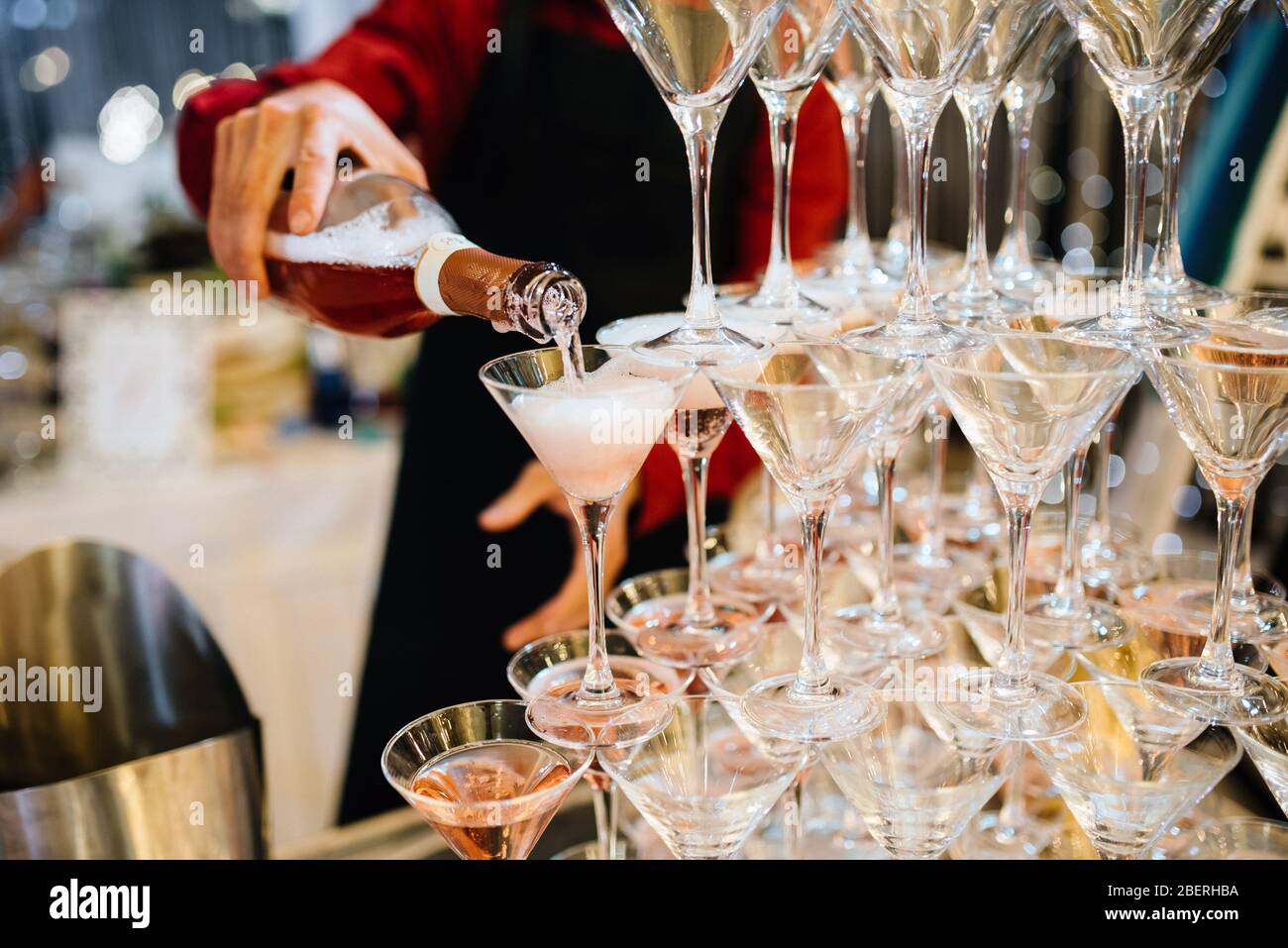 Person holding bottle of champagne serving Pyramid of Delicious Alcohol ...