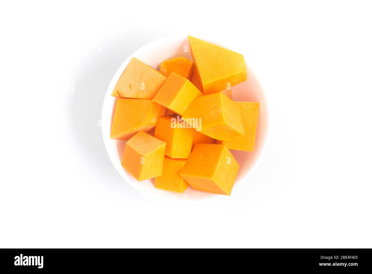 Diced Pumpkin in a bowl isolated on white background Stock Photo - Alamy