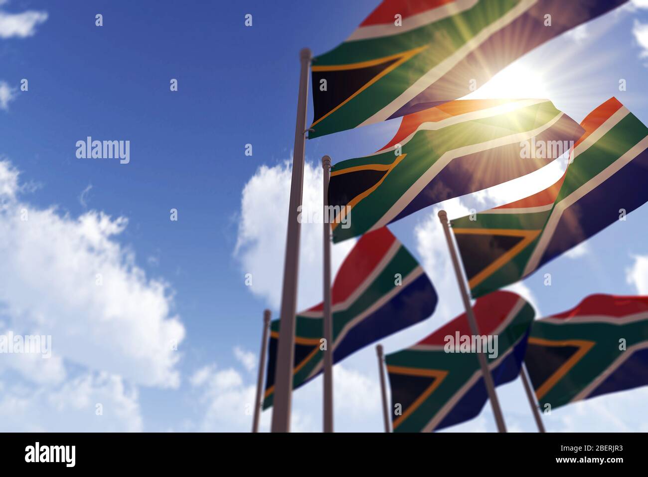 South Africa flags waving in the wind against a blue sky. 3D Rendering ...
