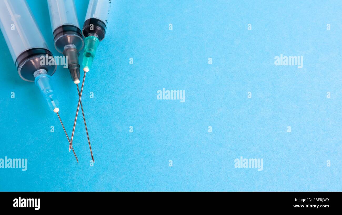 Three medical disposable plastic empty syringes with needles of ...