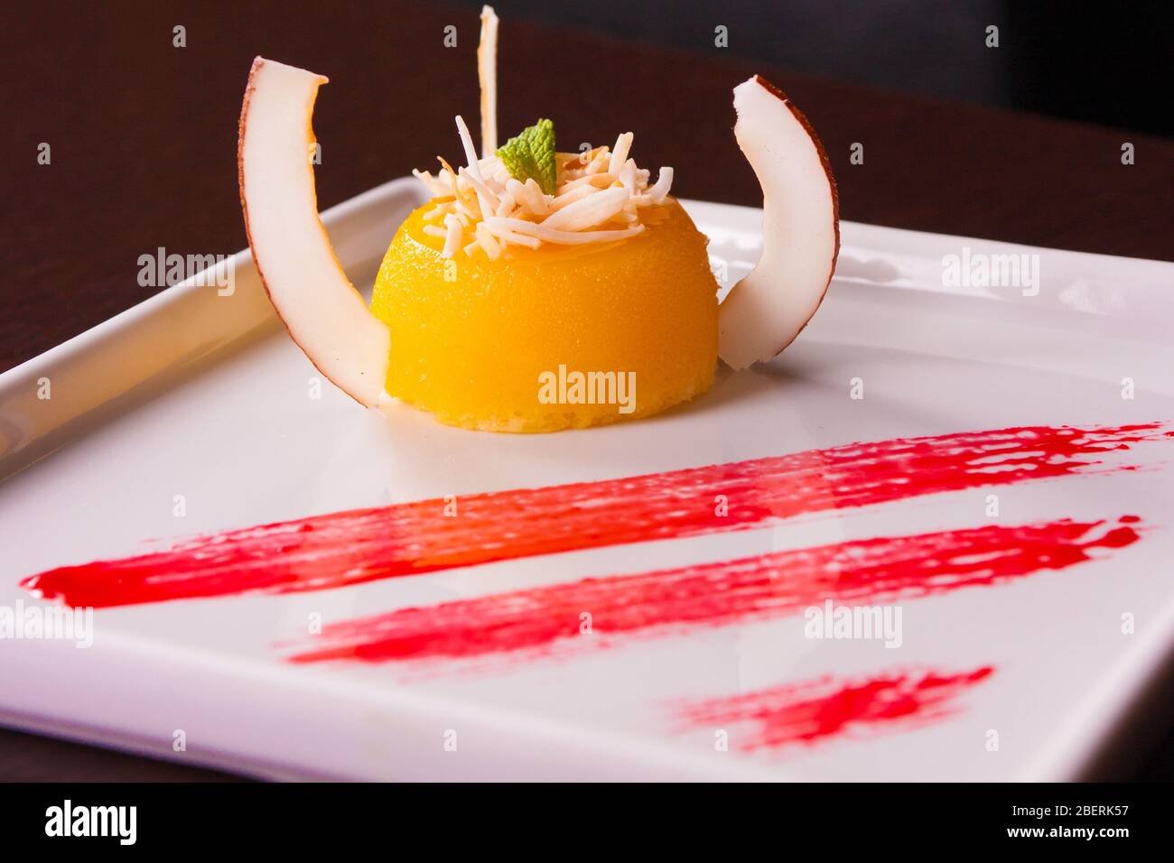 Egg Quindim dessert with slices of coconut Stock Photo - Alamy