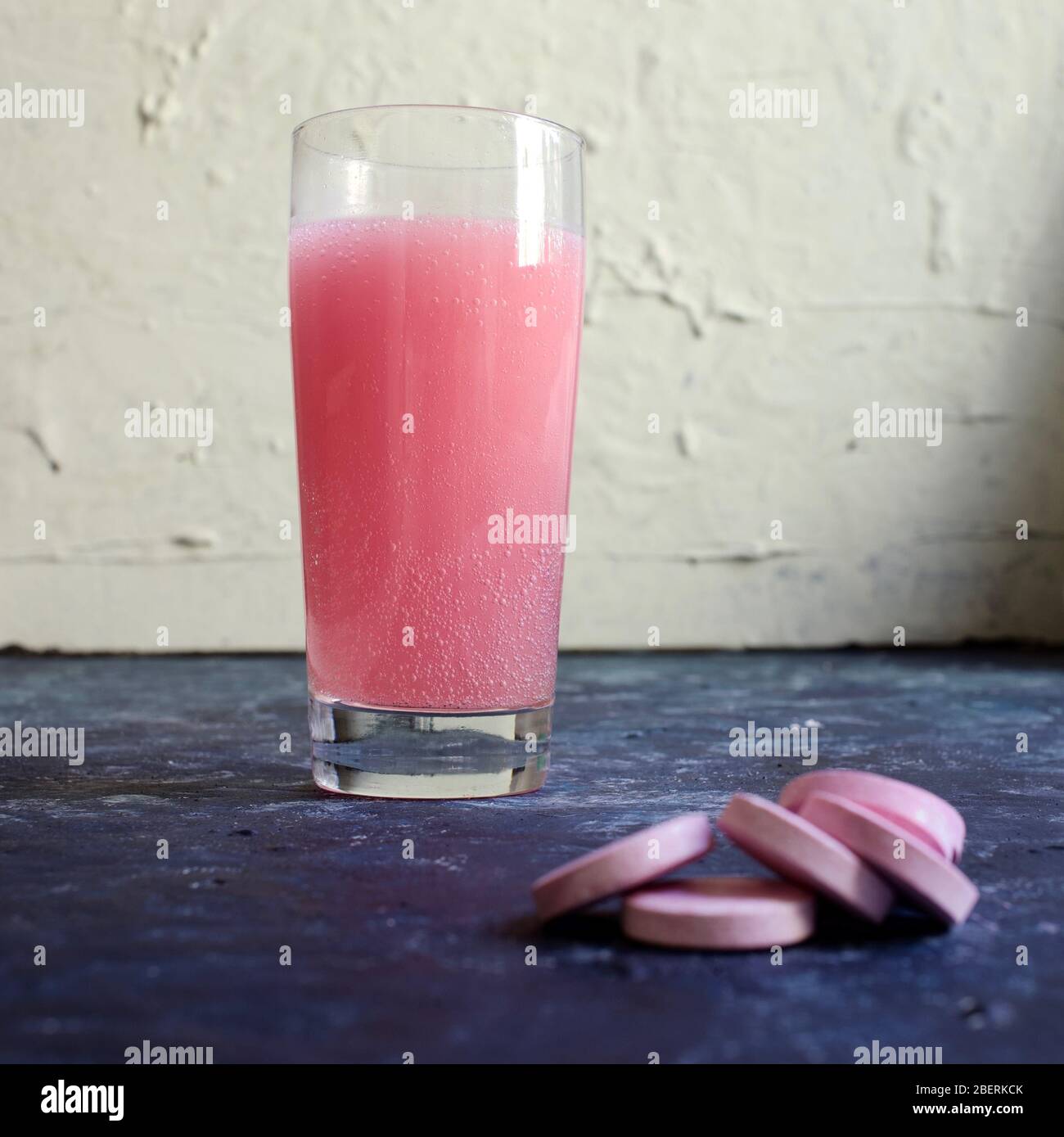 Fresh pink effervescent tablet drink on rustic background Stock Photo ...