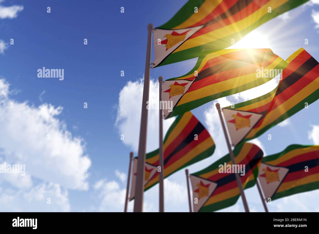 Zimbabwe flags waving in the wind against a blue sky. 3D Rendering ...
