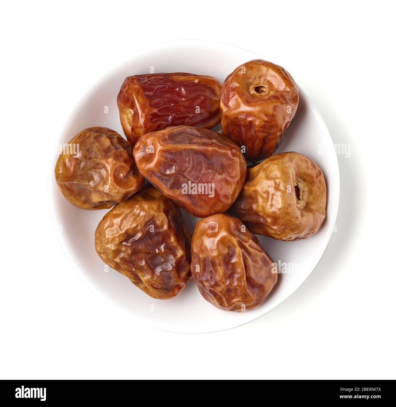Bowl of dates isolated on white background; top view Stock Photo - Alamy