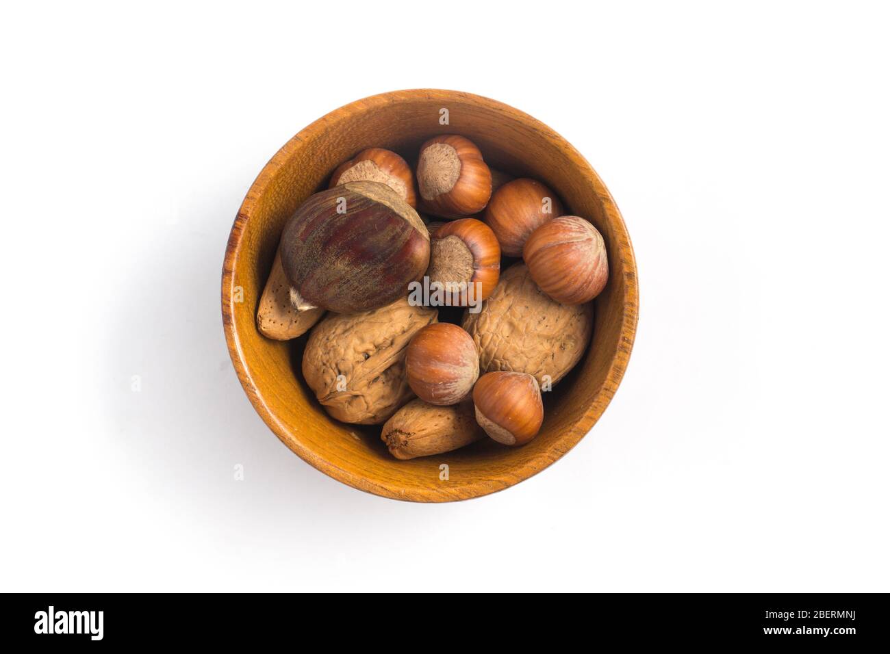 Whole Nuts into a bowl isolated on white background Stock Photo - Alamy