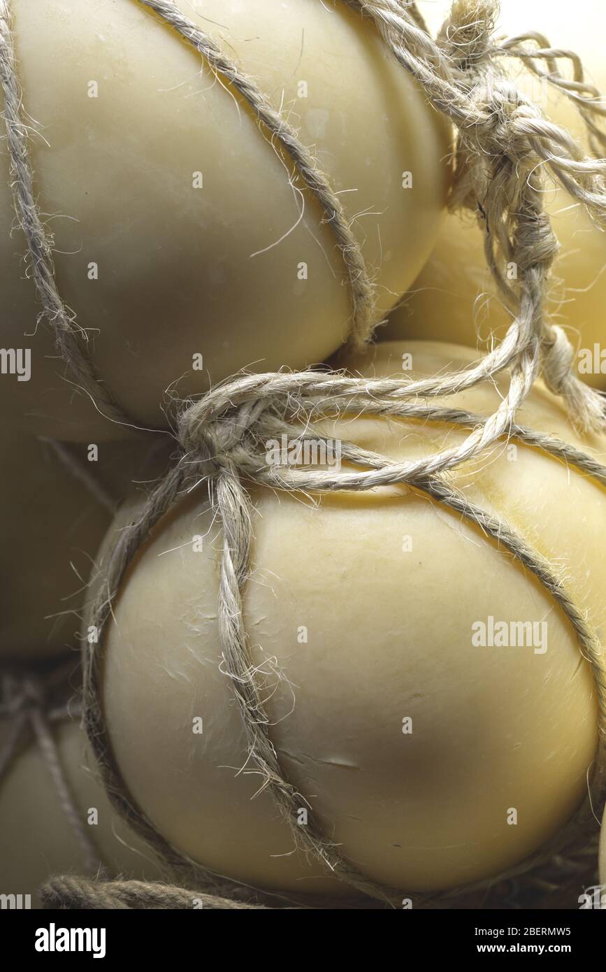 Italian rope tied provolone cheese close-up rustic composition Stock ...