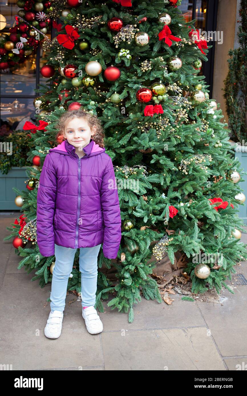 Posing by christmas tree hi-res stock photography and images - Alamy