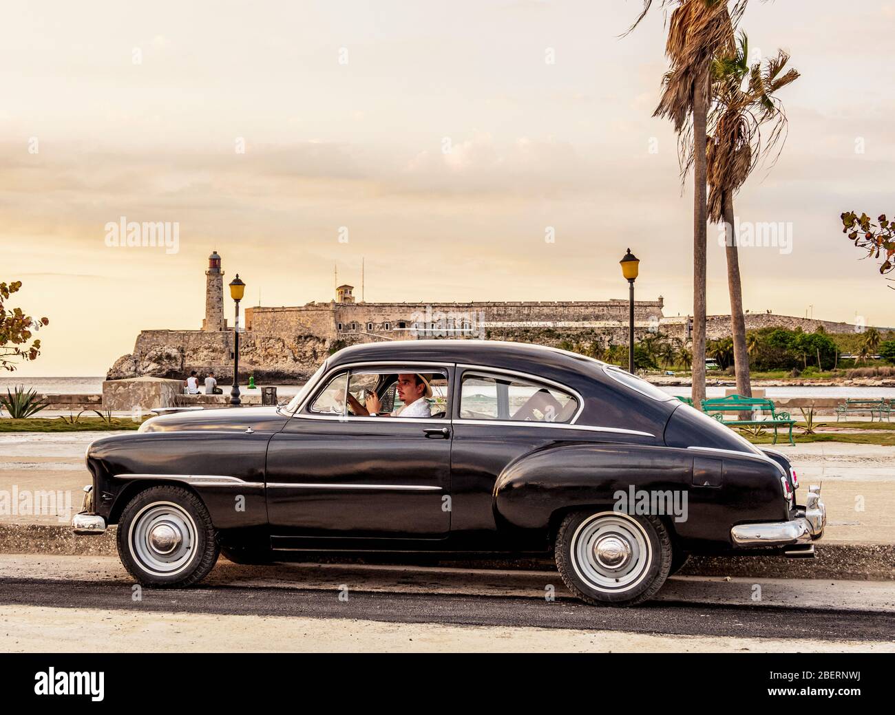 Cuban model smoking cigar in his Vintage Chevrolet Car at El Malecon ...