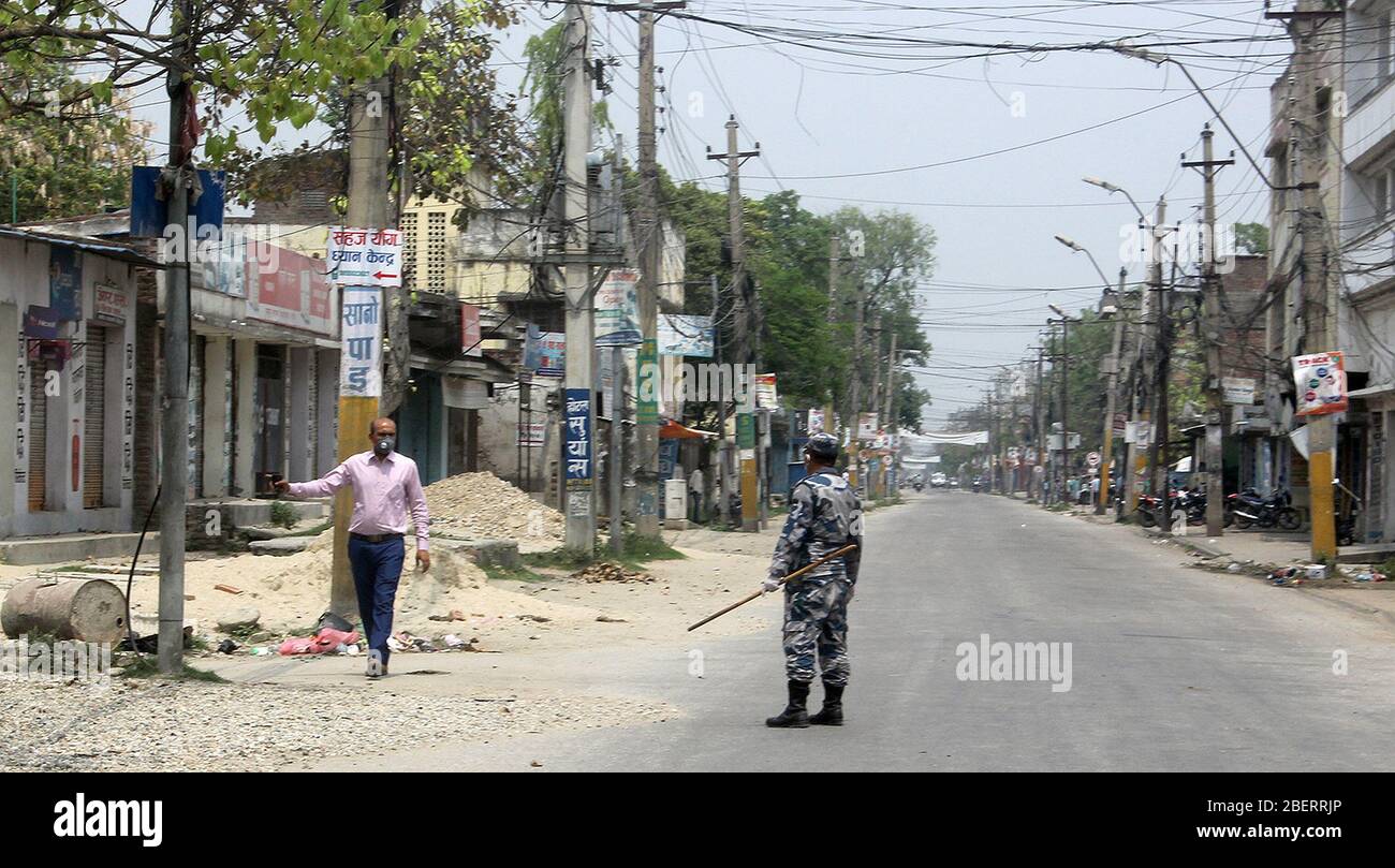 Birgunj. 15th Apr, 2020. A policeman interrogates a man who violates ...