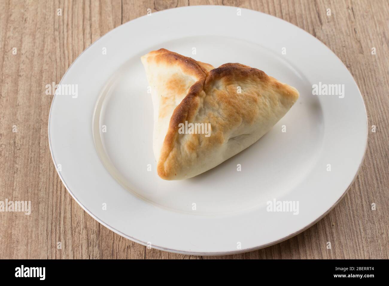 Arabic esfiha. Manakish over a wooden table Stock Photo - Alamy