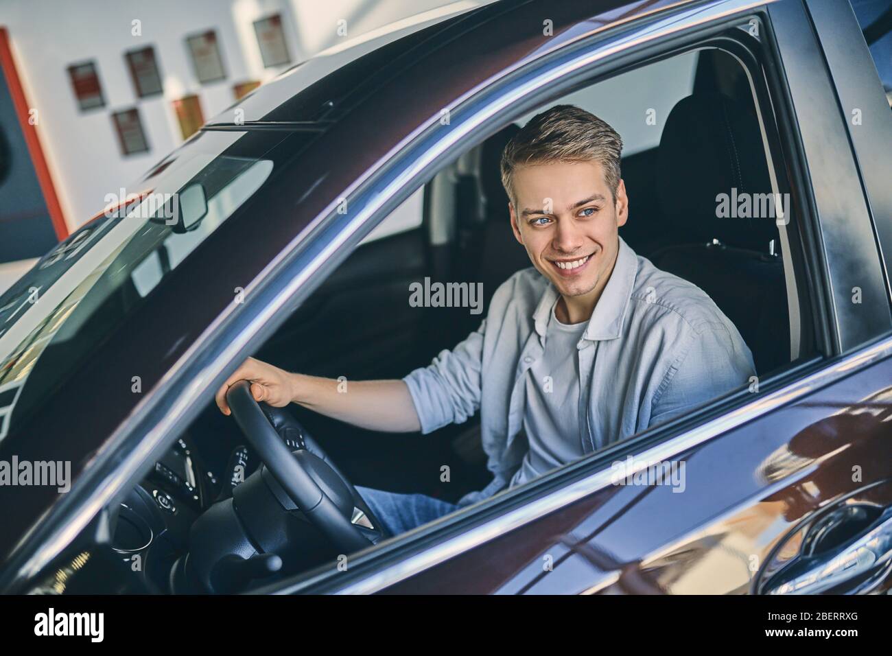 Stylish man sitting a new car and getting ready to drive Stock Photo ...