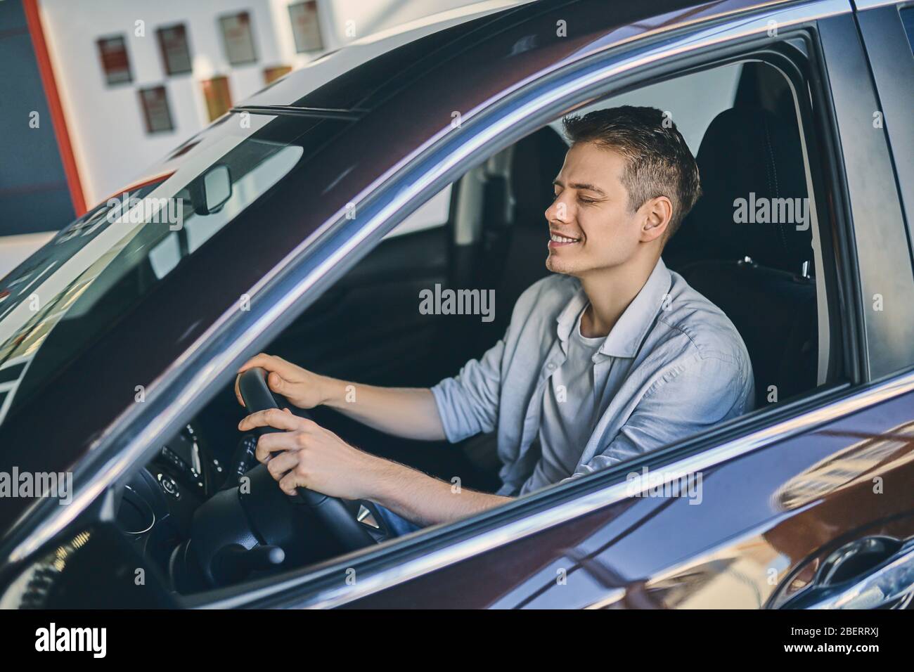 Stylish man sitting a new car and getting ready to drive Stock Photo ...