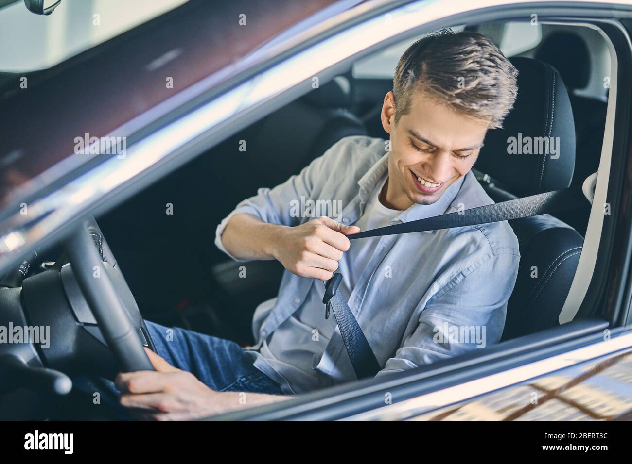 Stylish man sitting a new car and getting ready to drive Stock Photo ...