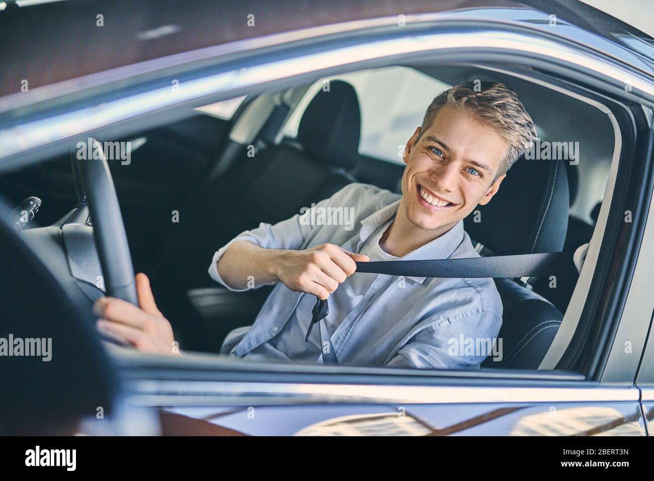 Stylish man sitting a new car and getting ready to drive Stock Photo ...