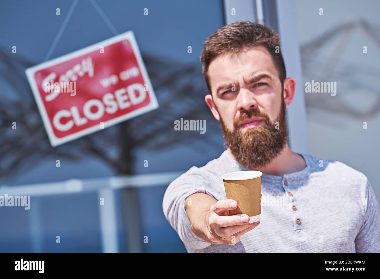 Bemused beggar man near closed-door of office. Unemployment during ...