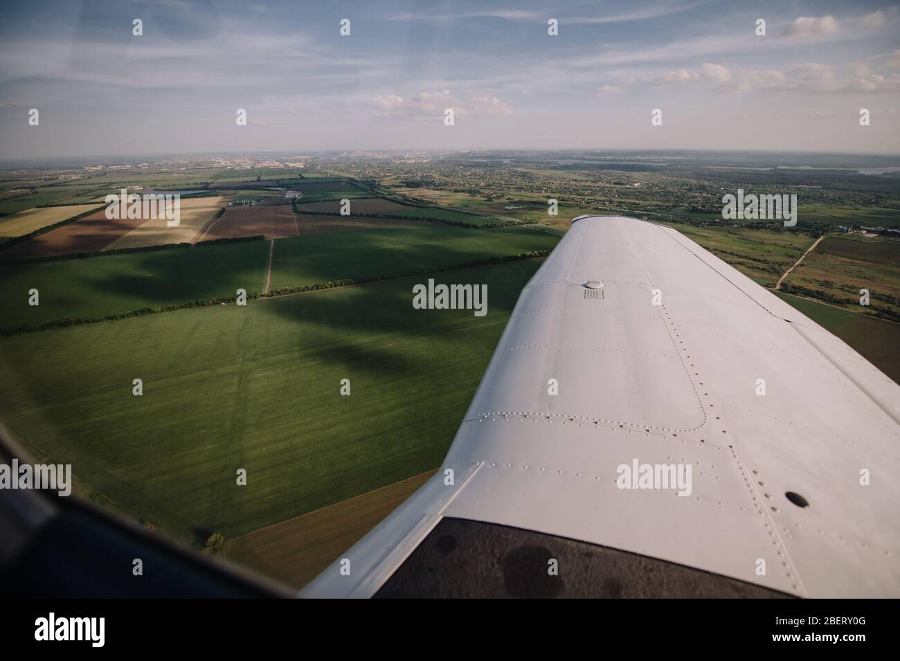 view from the airplane window to green fields Stock Photo - Alamy