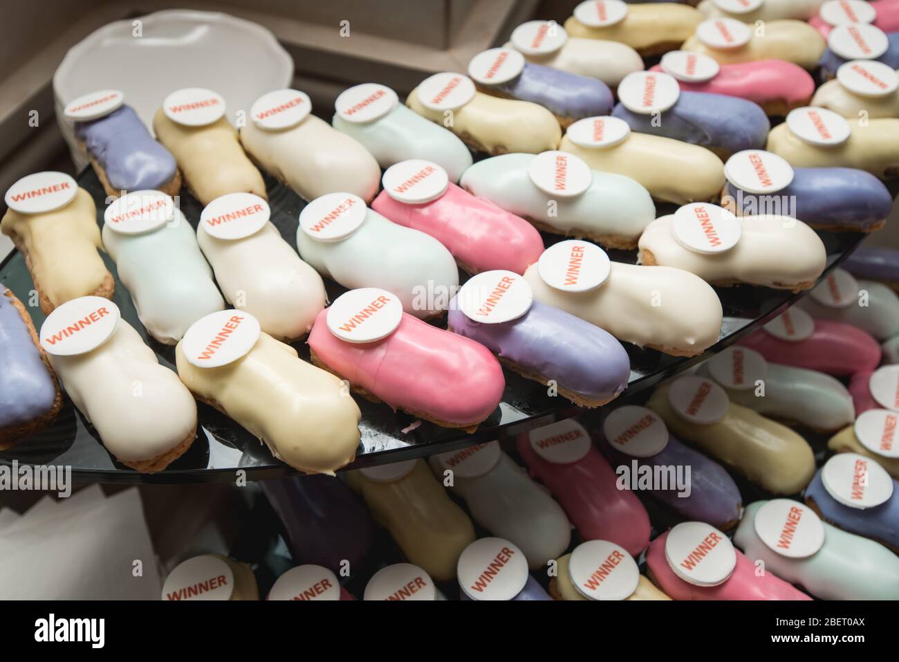 sweet and colorful eclair on glass. french eclair with word winner on ...