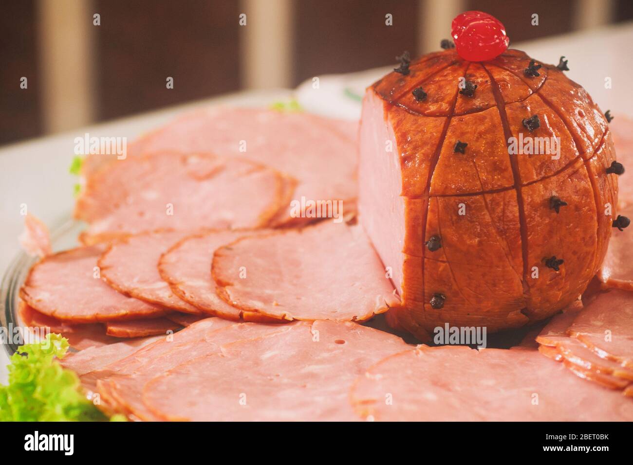 Smoked Christimas Ham Sliced with lettuce and blackhead Stock Photo - Alamy