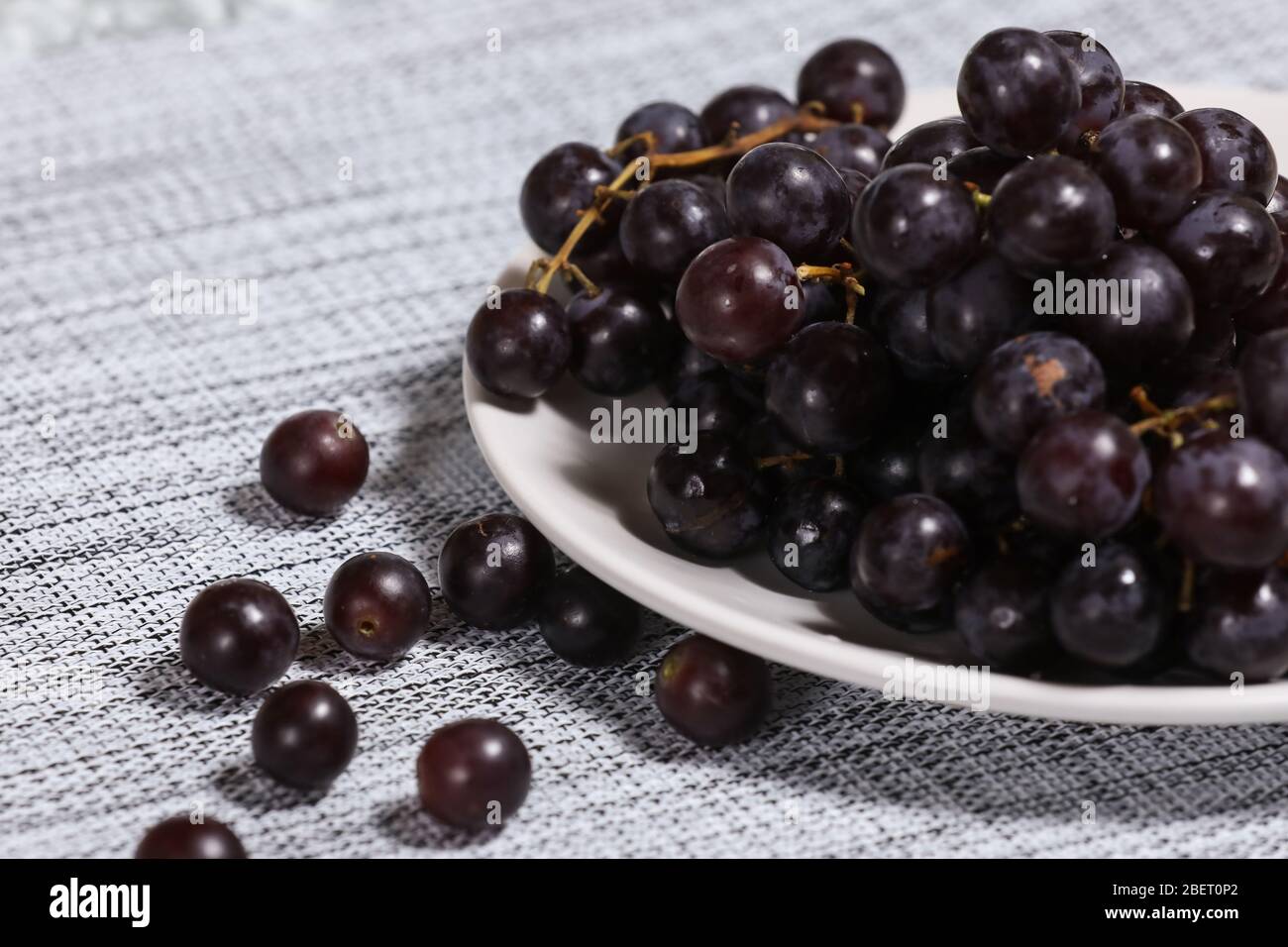 Big red grape on a kitchen table. Fresh natural vitamin Stock Photo - Alamy