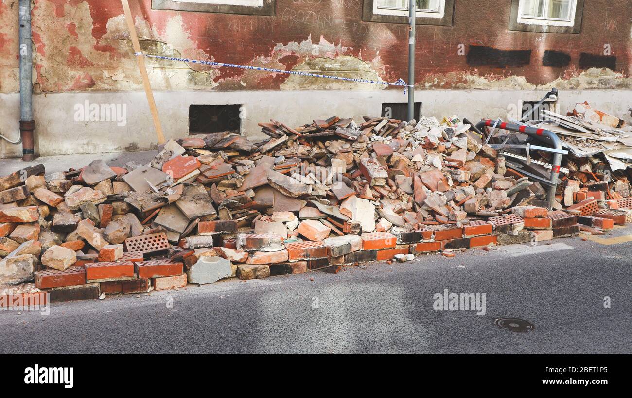 Broken bricks and debris fallen from damaged buildings on the street ...