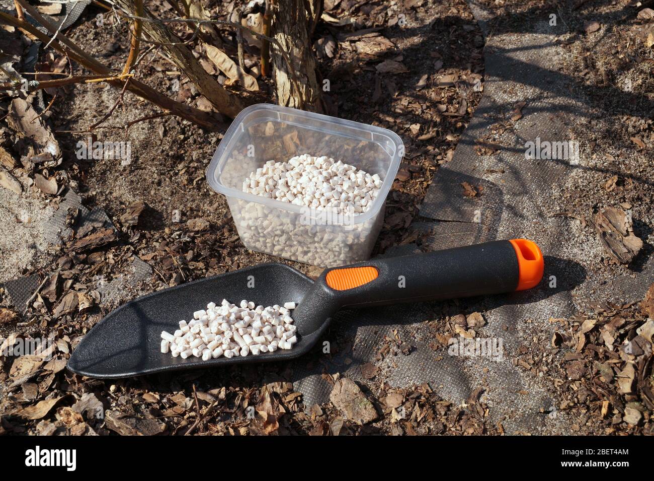 Box with fertilizer and a small gardening shovel. Plant fertilization ...