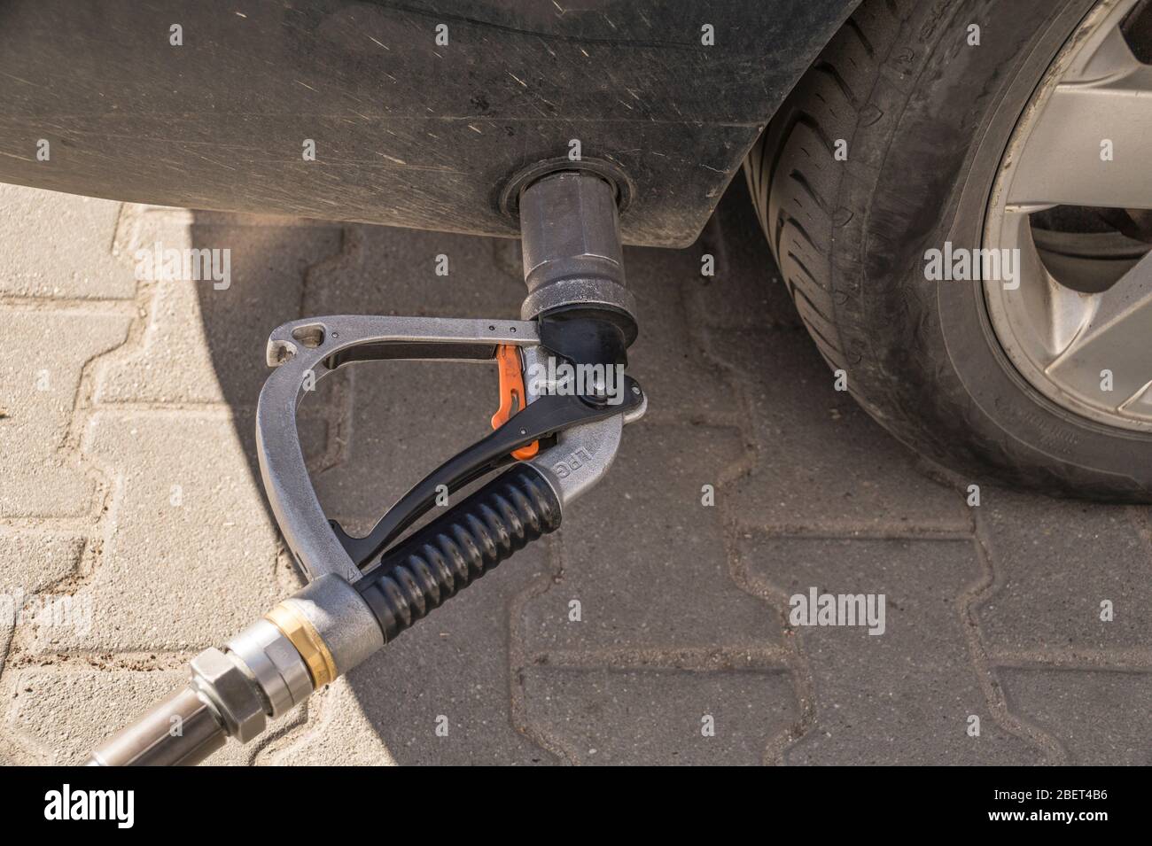 LPG (liquefied petroleum gas) dispenser. LPG refueling gun plugged into ...