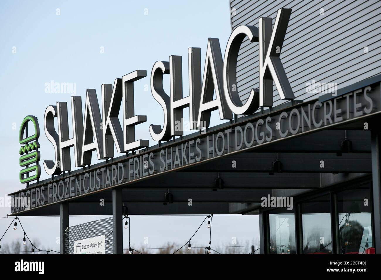 A logo sign outside of a Shake Shack restaurant location in Newark ...