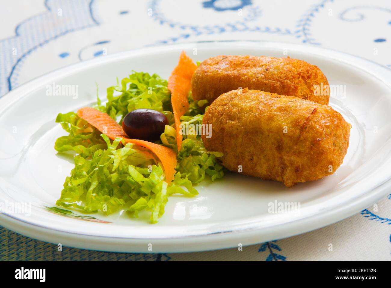 Traditional Portuguese Cod Cake with salad Stock Photo - Alamy