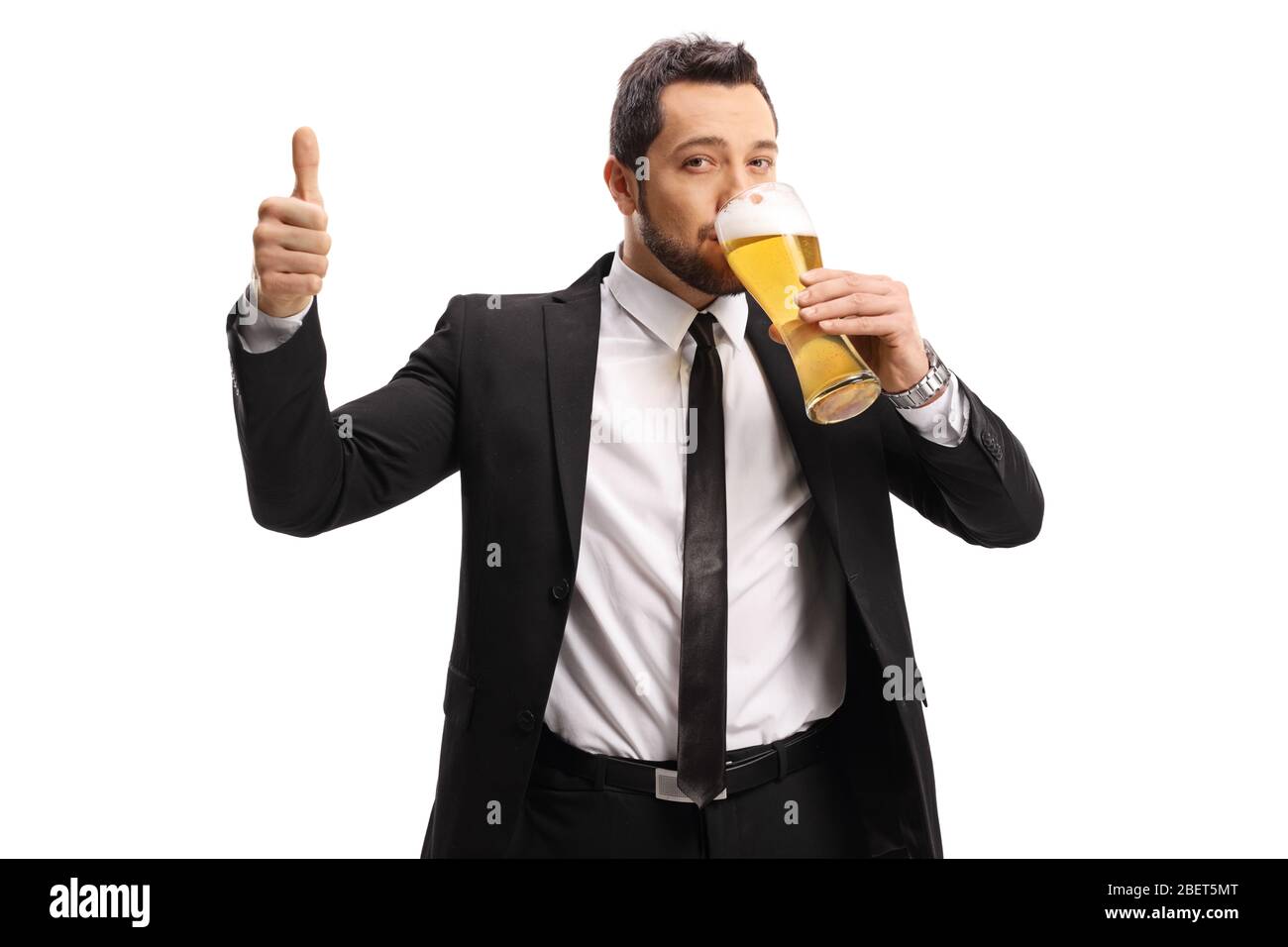 Young man in a suit and tie drinking beer and showing thumbs up ...