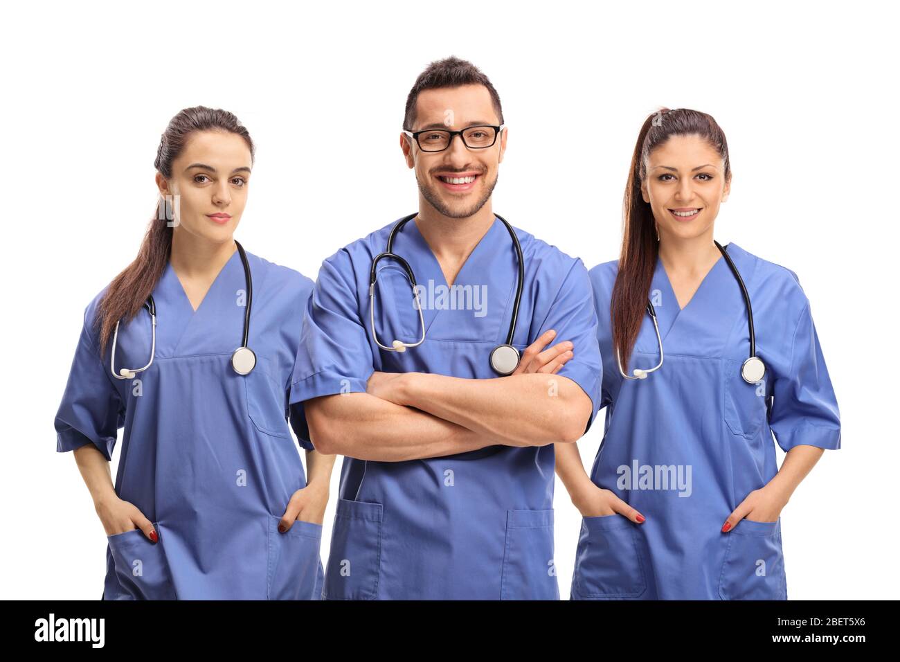Team of young healthcare workers in blue uniforms isolated on white ...