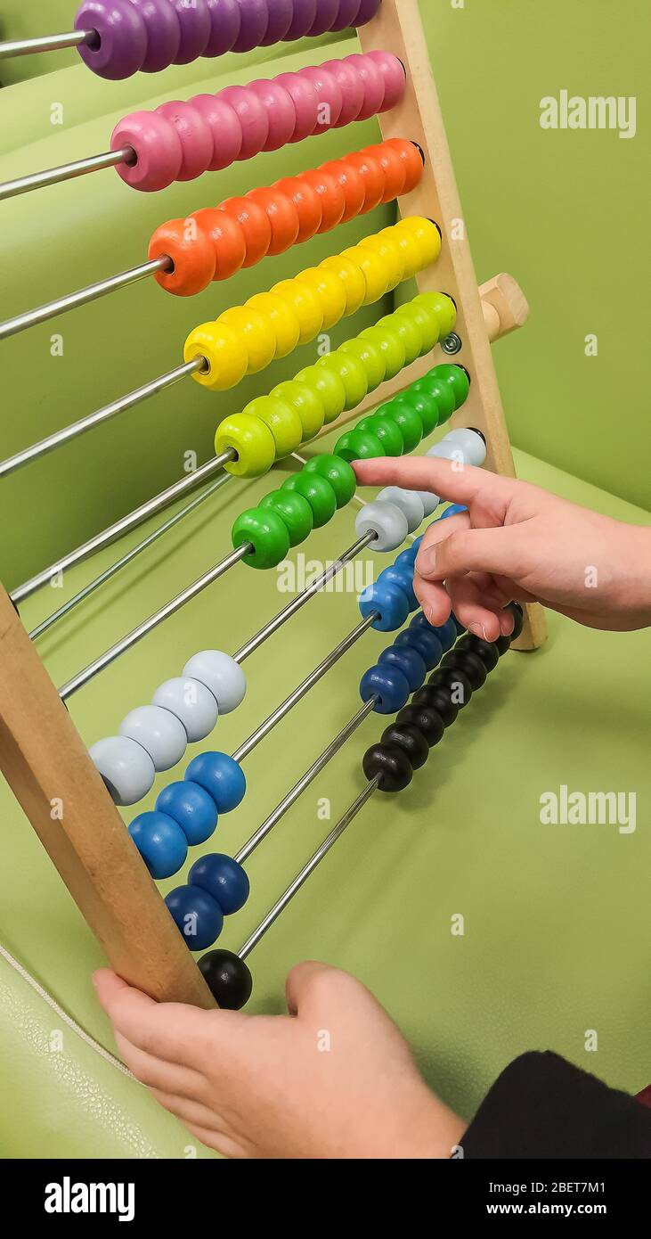 The concept of children's economic education. Kids hand playing with ...