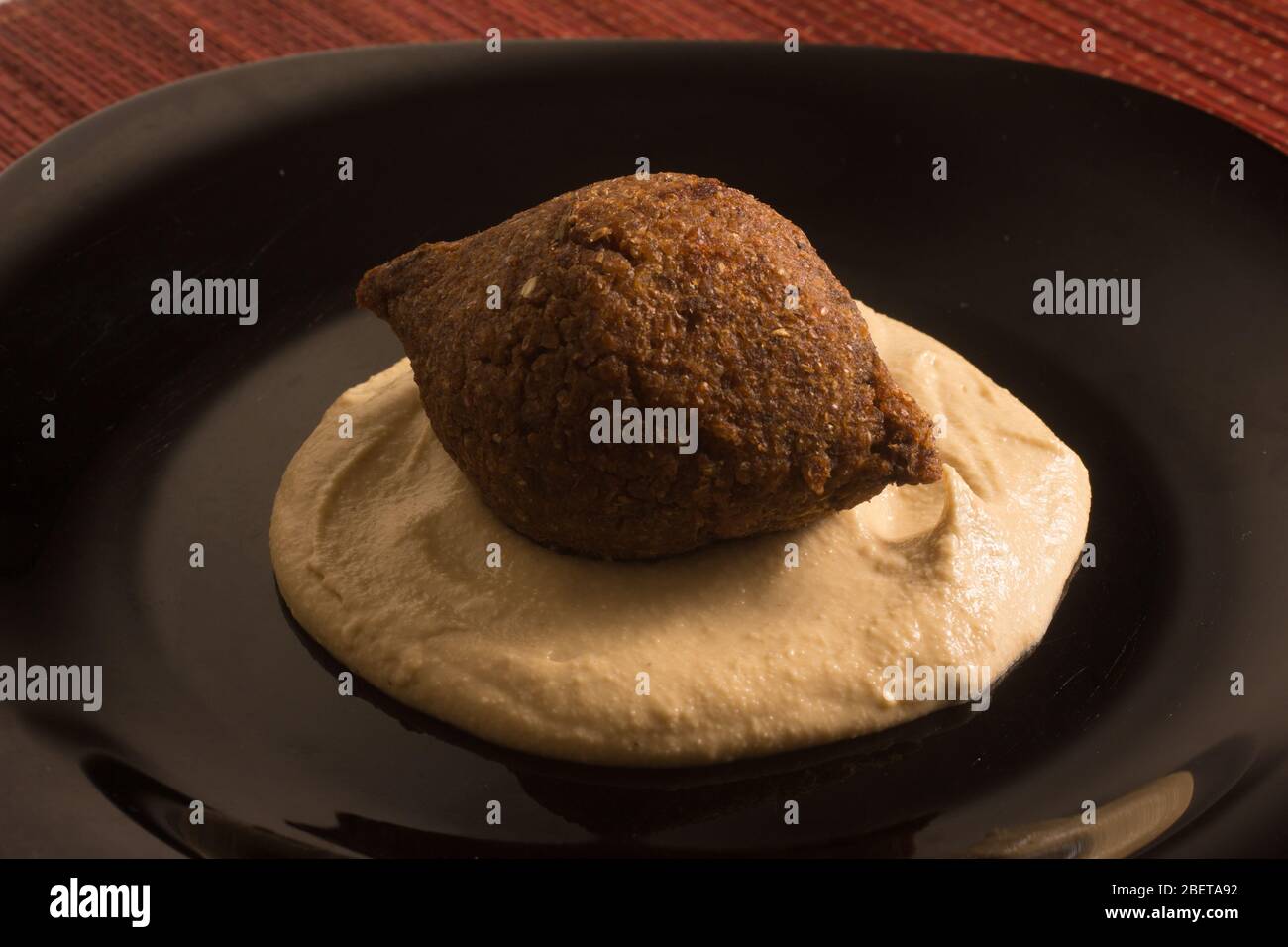 Kibbeh or Kibe, Quibe with Hummus. Close-up photo Stock Photo - Alamy
