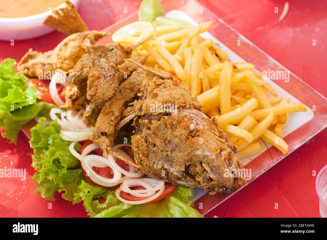 Brazilian fried fish with fries and salad Stock Photo - Alamy