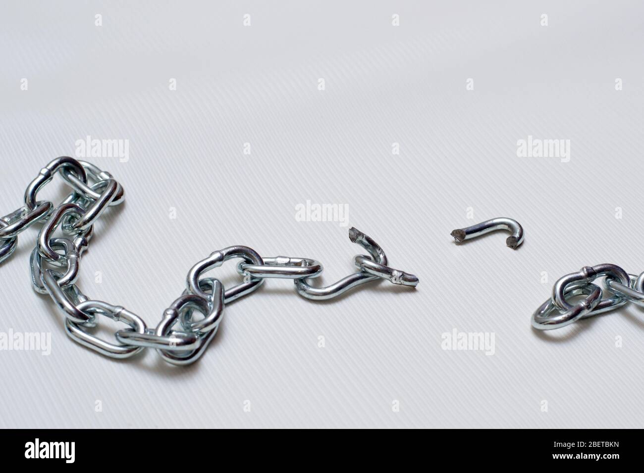 Photo of broken metallic chain on white background Stock Photo - Alamy Photo of broken metallic chain on white background Stock Photo - Alamy