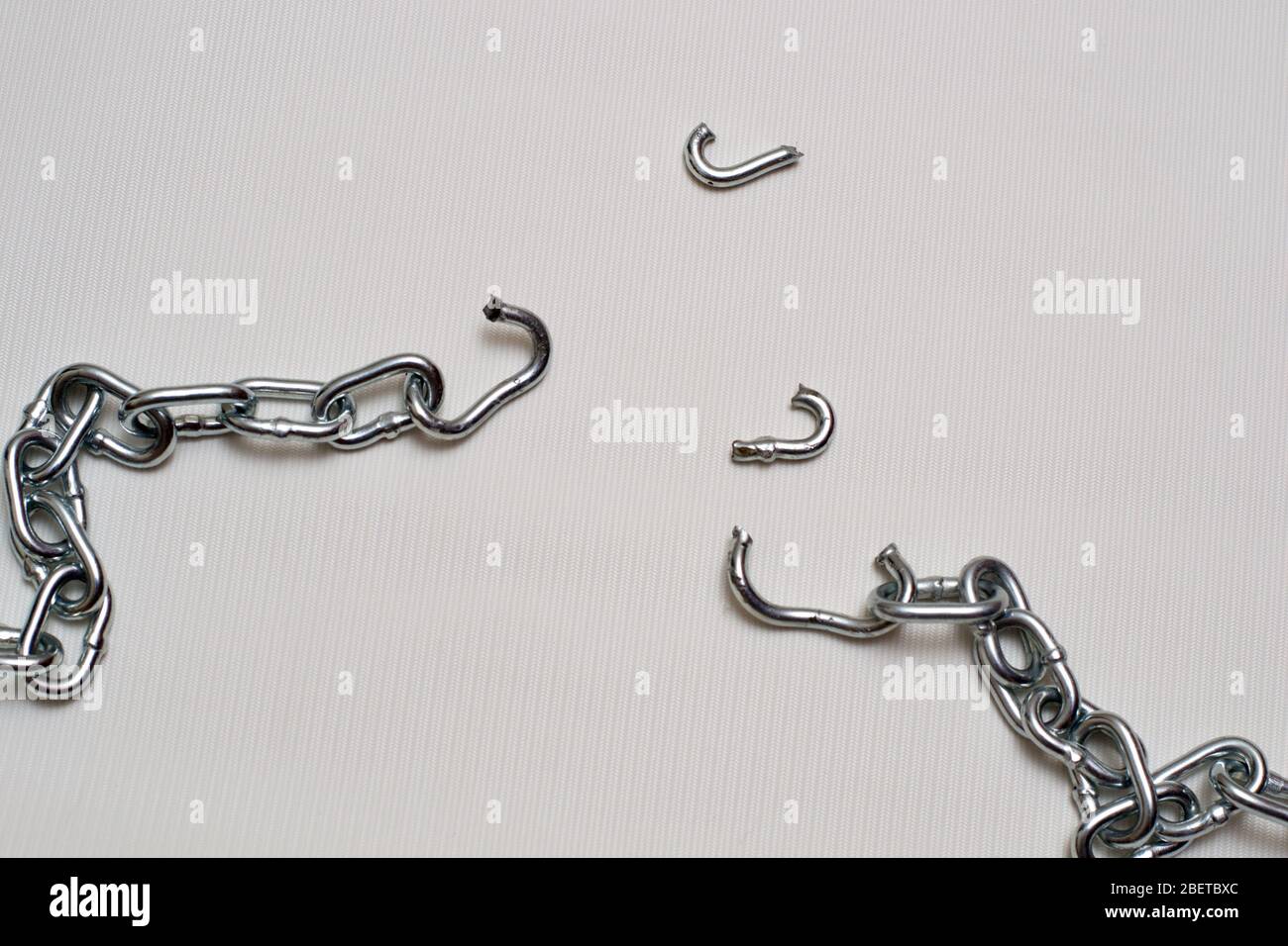 Photo of broken metallic chain on white background Stock Photo - Alamy Photo of broken metallic chain on white background Stock Photo - Alamy