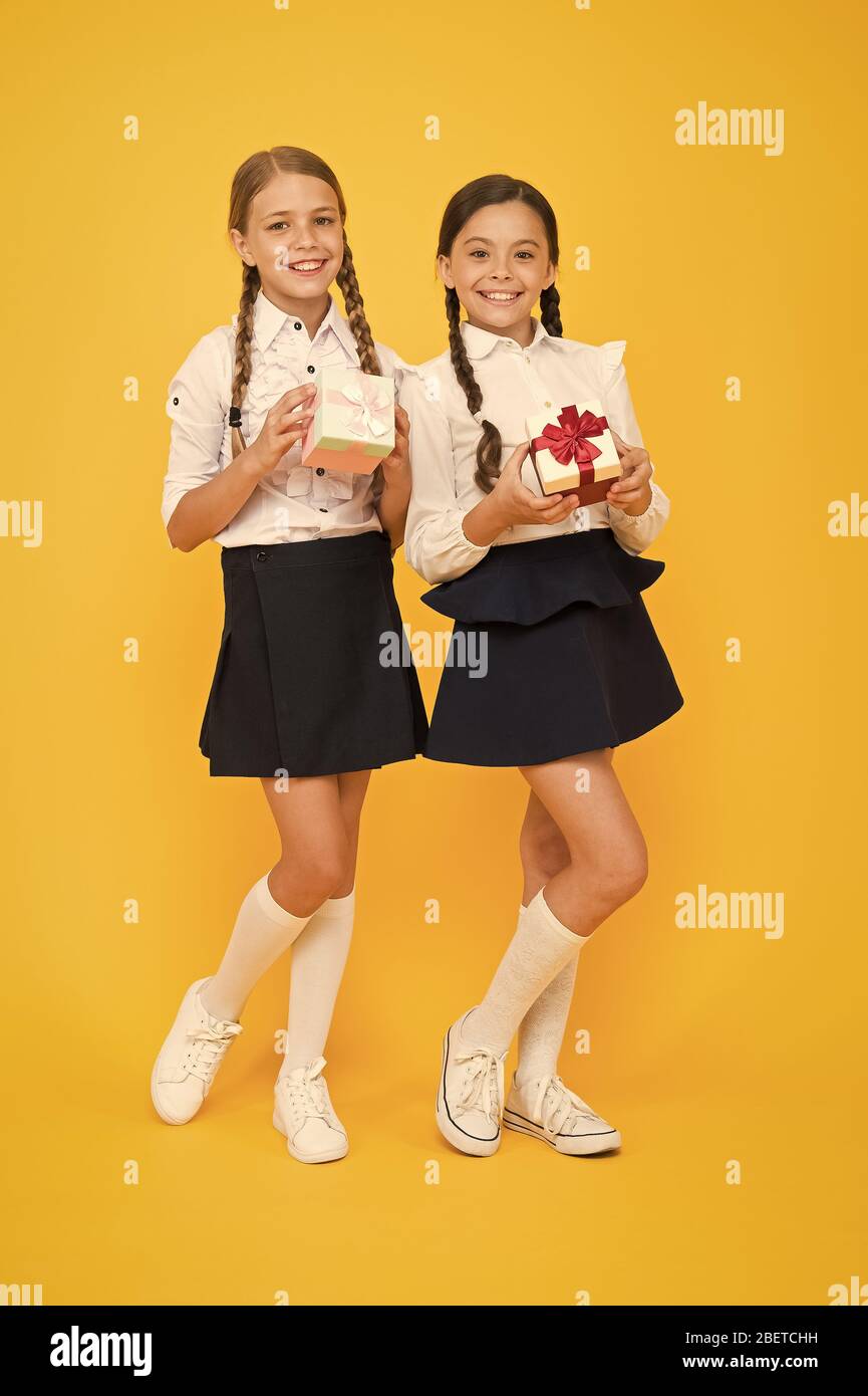 Gift shop. Happy small children holding gifts on yellow background ...