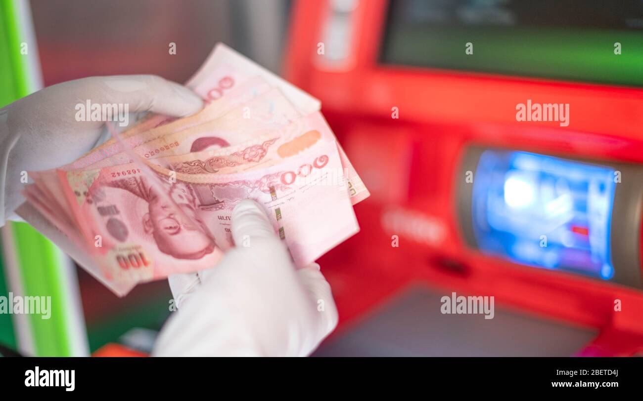 Female hands to holding cash from ATM key in the red cabinet. Finger ...