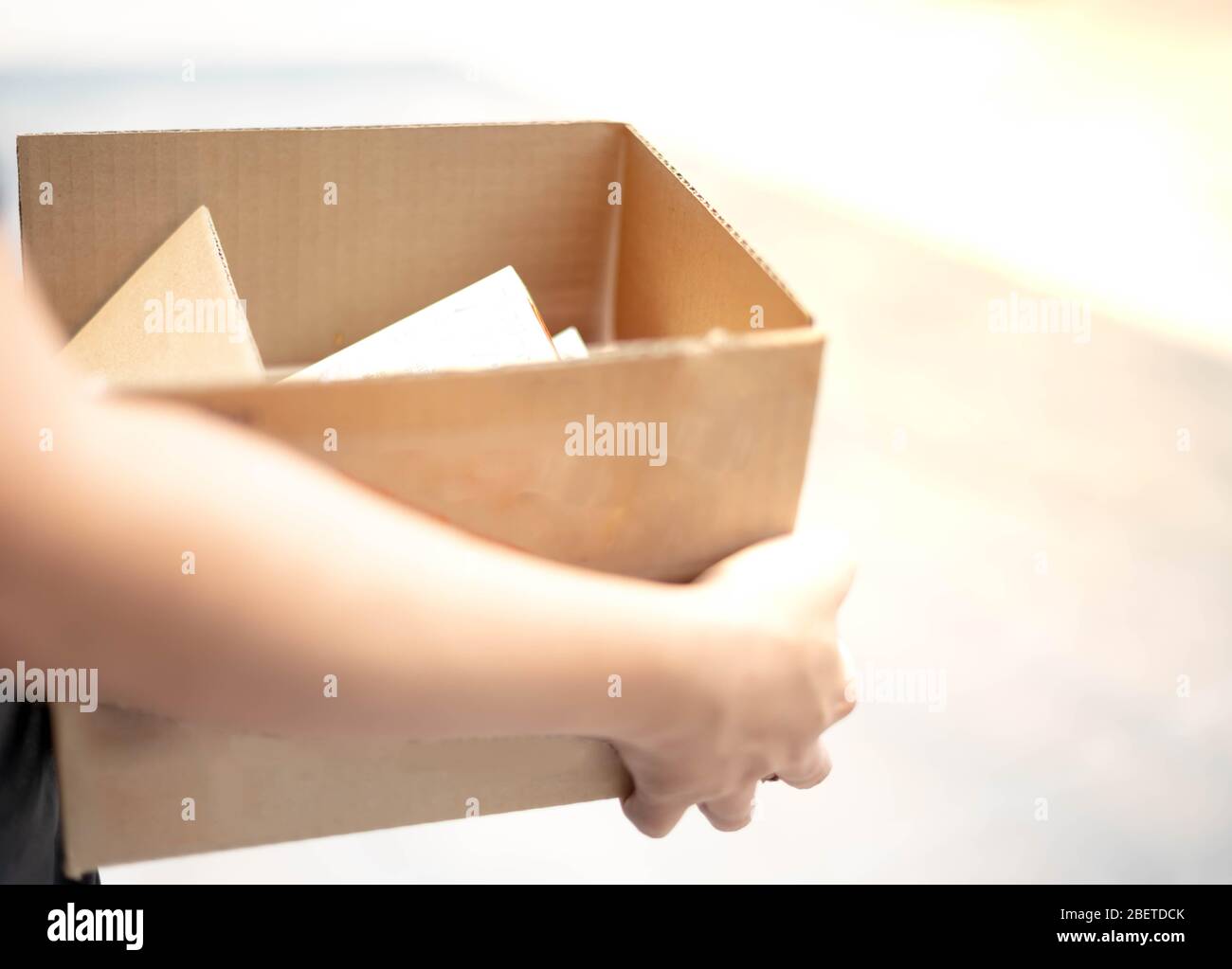 Delivery man hand carrying cardboard box packaging for logistic ...