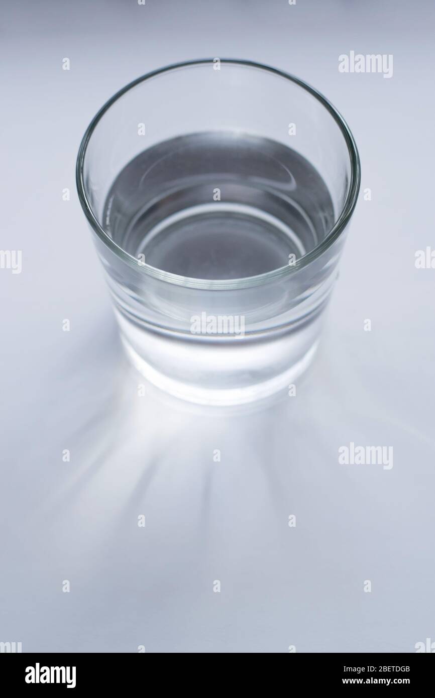 A glass of pure water on a light background Stock Photo - Alamy