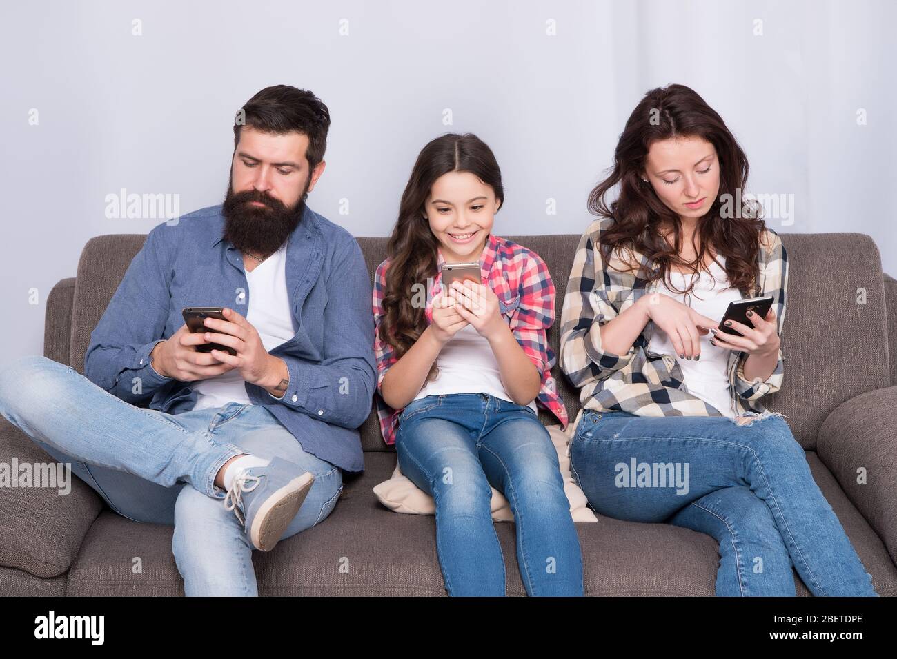 Family mobile connection. Family pick up mobile phones at home. Little ...