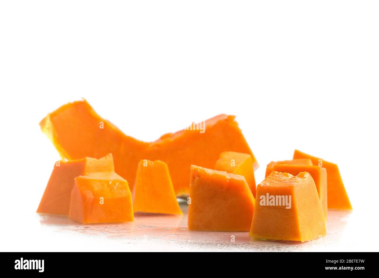 Diced Pumpkin Isolated in white background. Wet surface Stock Photo - Alamy