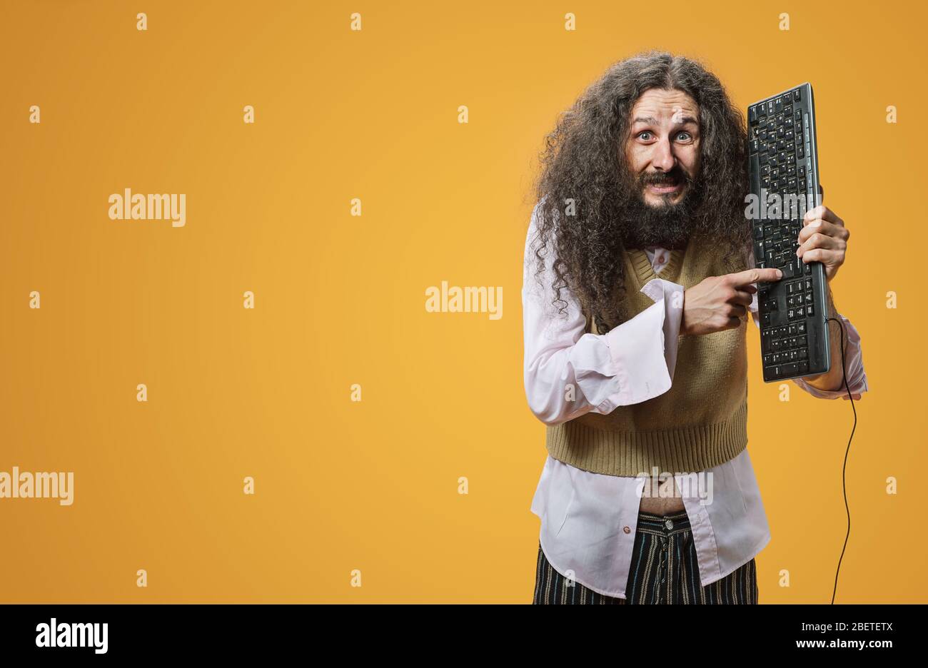 Weird, funny nerd posing wit a black pc keyboard Stock Photo - Alamy