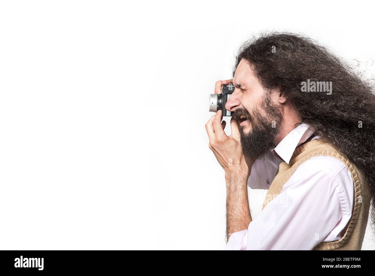 Skinny geek taking a photo with a tiny camera Stock Photo - Alamy