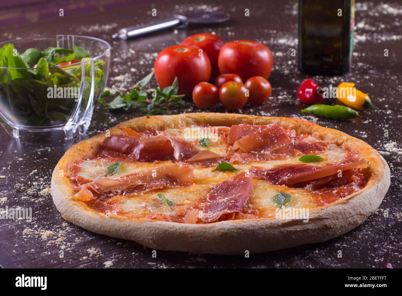 Traditional Ham pizza with parmegiano cheese and basil Stock Photo - Alamy